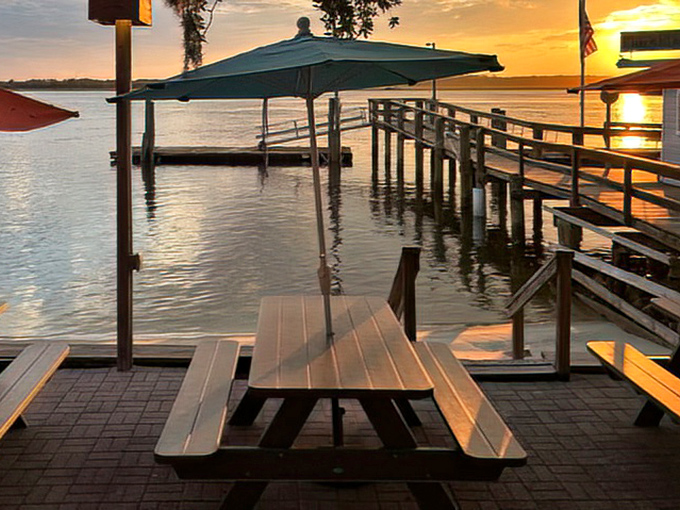 Sunset dining at its finest. This waterfront picnic table has witnessed more "oohs" and "aahs" than a fireworks display.