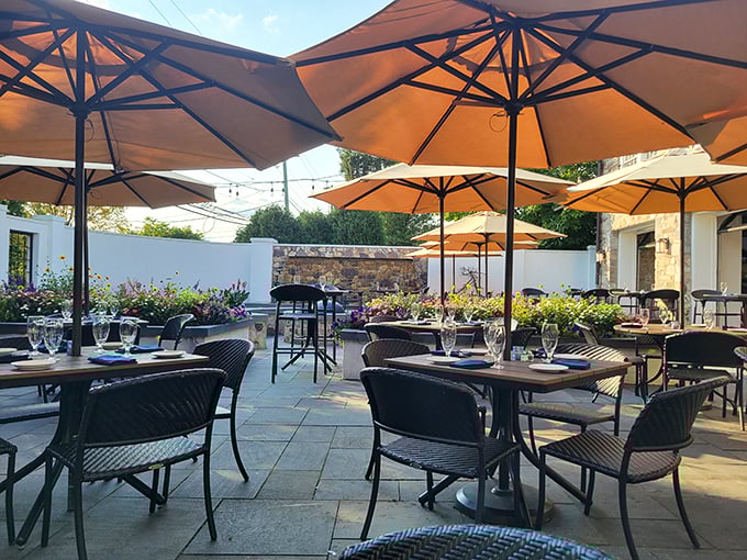The outdoor patio where umbrellas create islands of shade and every table feels like the best seat in the house.