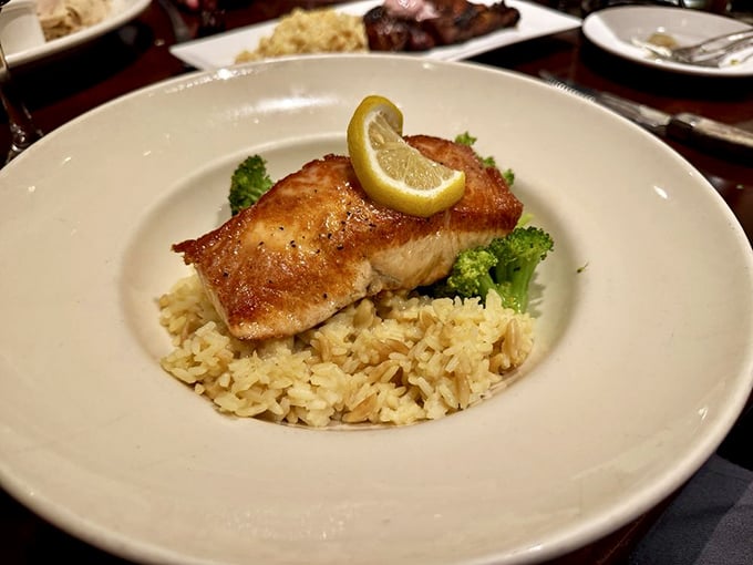Pan-seared salmon perched on a throne of rice with a lemon crown – simple, elegant, and proof that Vic Stewart's excels beyond just beef.