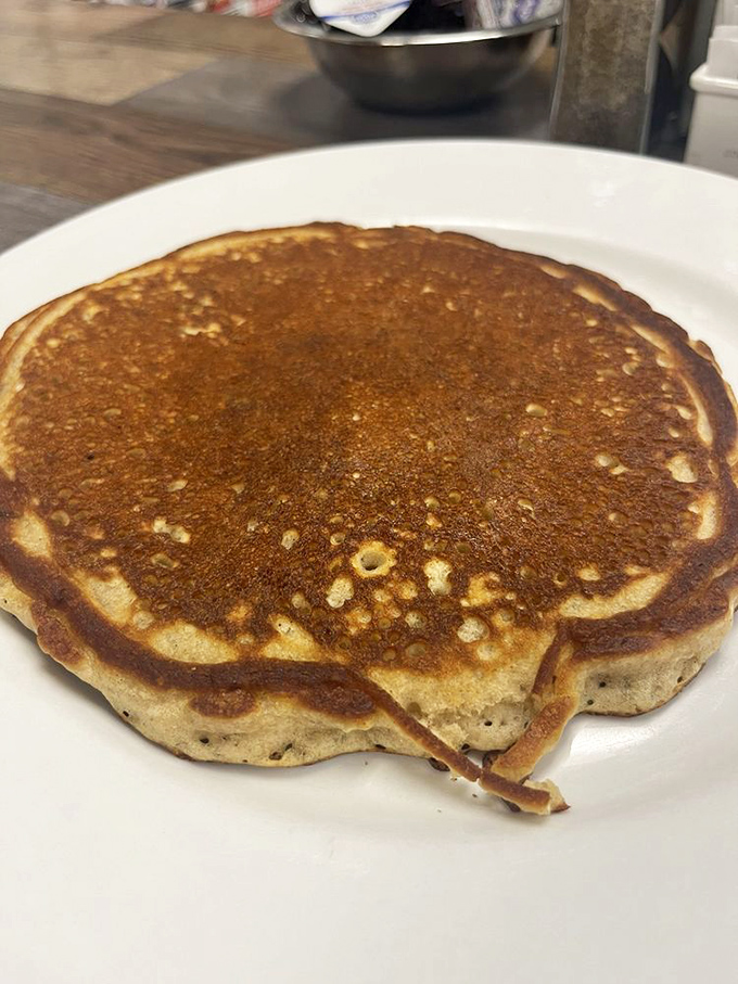 A perfectly golden pancake that's achieved that mythical balance—crisp edges, fluffy center. Some might call it just a pancake; I call it breakfast nirvana.