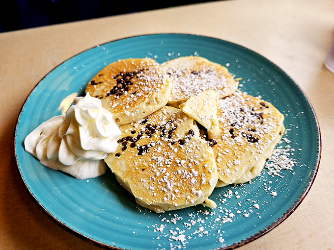 Silver dollar pancakes dusted with powdered sugar—little clouds of joy that prove sometimes the best things come in small, perfectly golden packages.