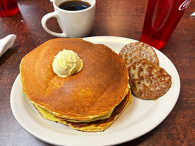 These pancakes don't need Instagram filters—their golden perfection and sausage sidekick create a breakfast duet worthy of a standing ovation.