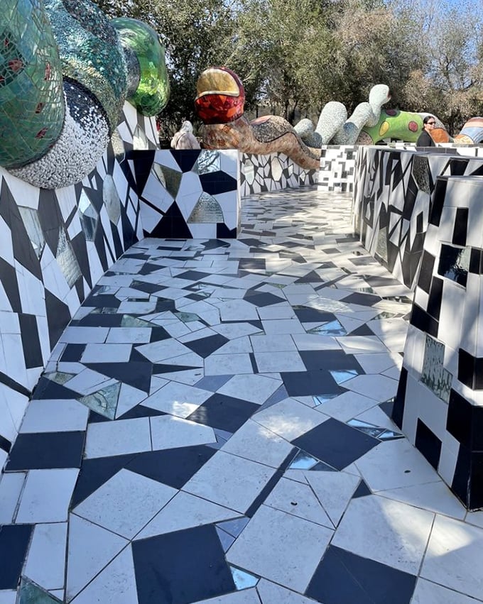 Walking this black-and-white maze feels like navigating a chess game designed by Salvador Dalí after a particularly vivid dream.