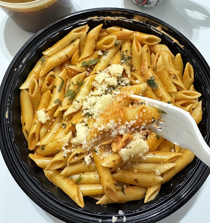 Penne pasta that doesn't need to show off with fancy plating—it knows its rich sauce and generous dusting of parmesan speak volumes.