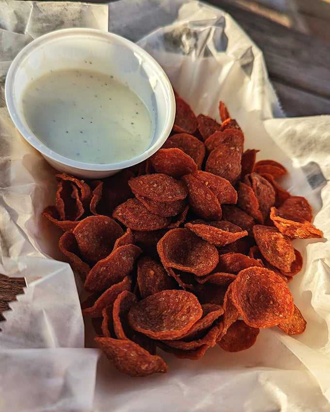 Crispy pepperoni chips with creamy dip—proof that the simplest snacks often create the most passionate devotees.