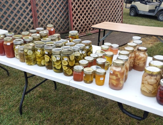 Mason jar magic! Pickles, peaches, and preserves line up like edible jewels, each representing hours of kitchen alchemy and generations of handed-down recipes.