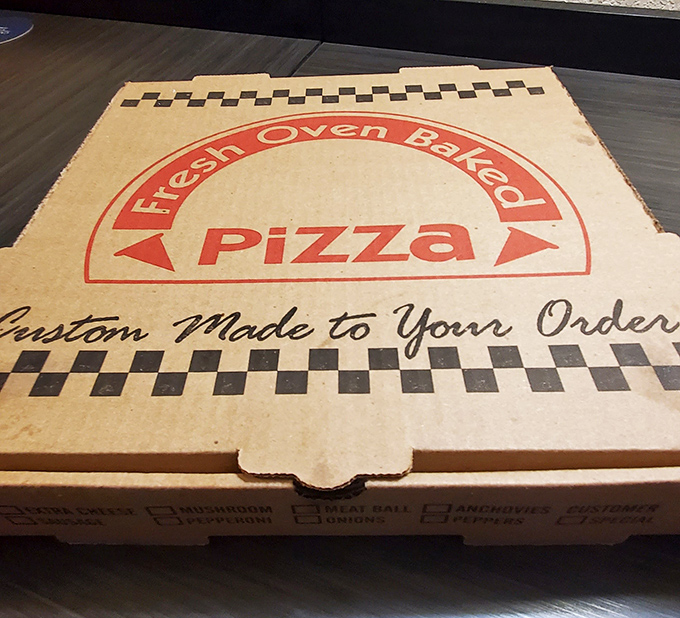 "Custom Made To Your Order"—the pizza box promises what every great neighborhood joint delivers: food made for you, not for Instagram.