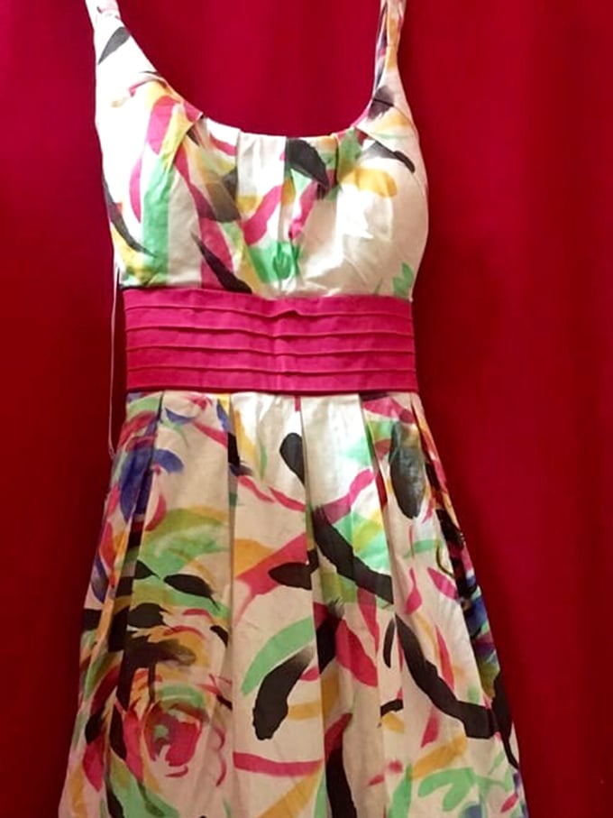 A splash of watercolor florals on crisp fabric—this dress is summer incarnate. Someone's impulse buy becomes your signature piece.