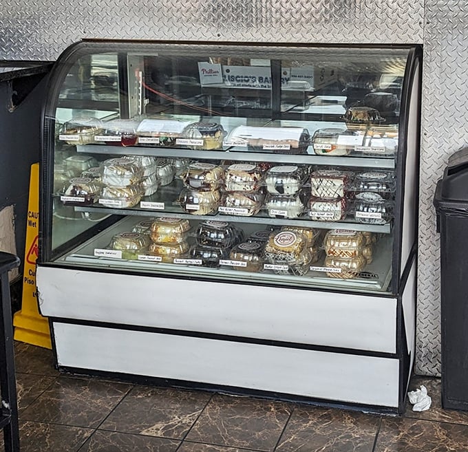 The display case—a treasure chest of ready-to-go delights for those wise enough to grab extras for later.