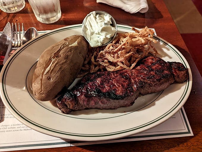 A steak dinner with all the fixings—where the potato comes dressed for the occasion and the onion strings add a crispy crown.