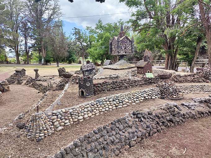 A miniature stone village emerges from the landscape, with pathways and walls creating a topographical dreamscape that begs for exploration.