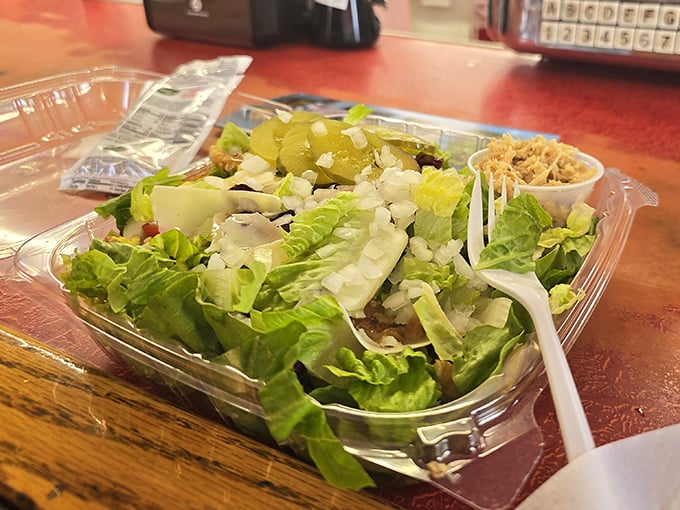 Even the salad gets the respect it deserves—crisp lettuce, fresh toppings, and what appears to be a side of that famous turkey, because vegetables need friends too.