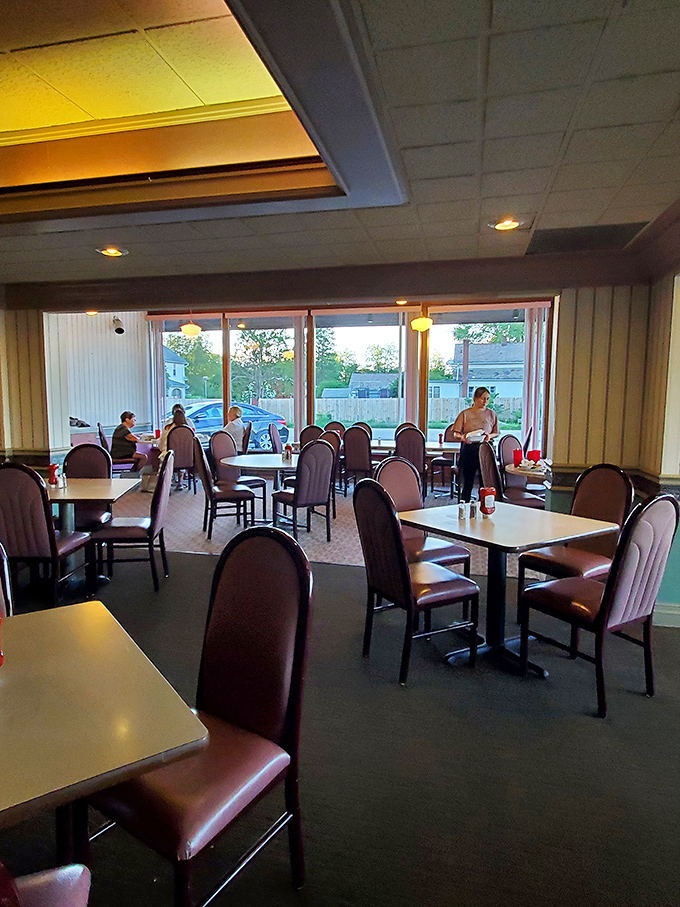 Evening light streams through windows illuminating tables where memories are made between bites of legendary fried chicken.