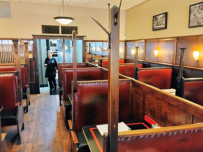 Classic red booth seating arranged in neat rows—the kind of place where important life decisions have been made over plates of comfort food.