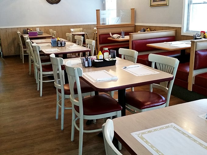 Red booths and cream chairs—the classic diner uniform worn with pride. This isn't interior design; it's a commitment to tradition.