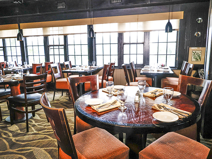 Rich wood tones and comfortable seating create the perfect stage for the culinary performance that unfolds at each table.