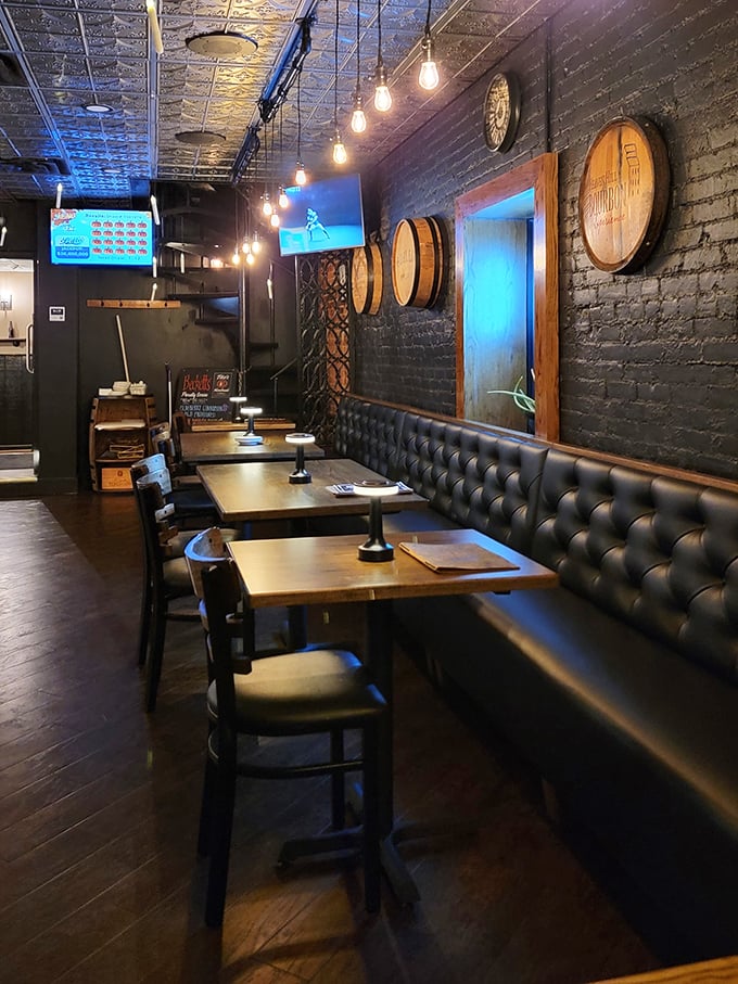 Leather booths and barrel accents create dining nooks that feel both exclusive and welcoming—the restaurant equivalent of a firm handshake.