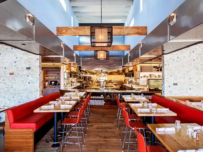 Red banquettes and wooden tables create a dining room that balances nautical heritage with modern California design—comfortable yet sophisticated enough for a special occasion.