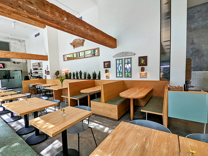 Wooden booths bathed in natural light create dining nooks that feel both communal and intimate—the restaurant equivalent of a perfect hug.