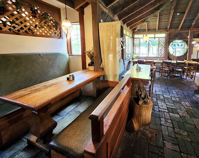 Rustic bench seating and brick floors create dining spaces that feel both intimate and communal – like dinner at your most interesting friend's cabin.