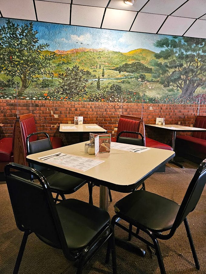 Simple tables beneath pastoral murals create an atmosphere that says, "Sit down, relax, and prepare for a meal that will haunt your dreams."