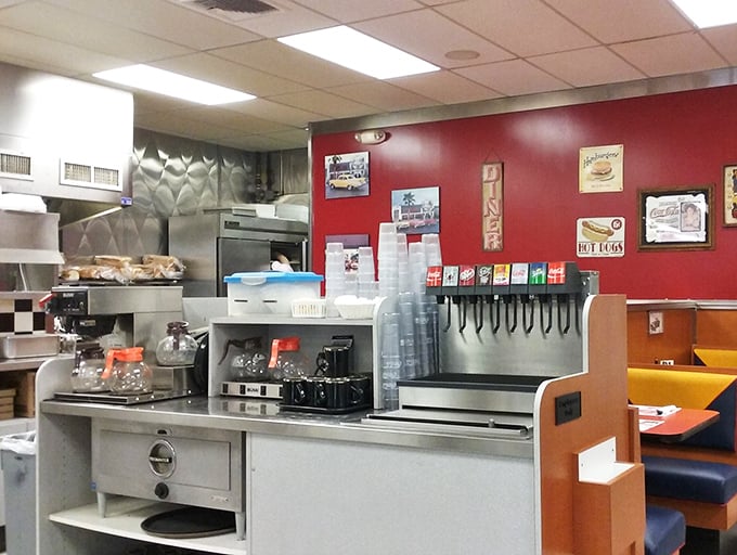 The coffee station—where morning transformation begins. That soda fountain has witnessed more Monday morning revivals than a motivational speaker.