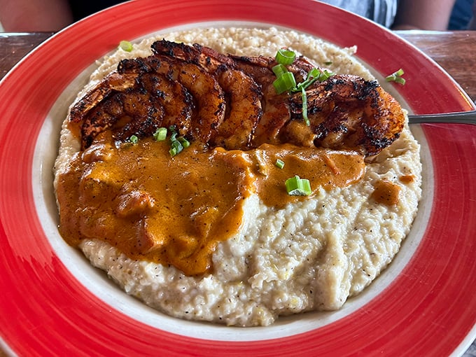 Blackened shrimp lounging on a bed of creamy grits like they're at their own beachfront resort. Southern comfort meets coastal luxury.