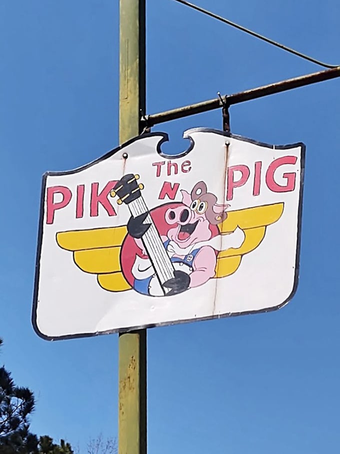 A flying pig with a guitar—because when your barbecue's this good, pigs really do soar. This sign promises musical flavors ahead.