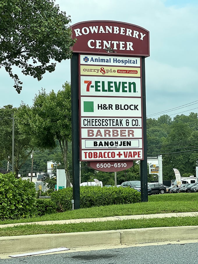 Nestled between 7-Eleven and a barber shop on the Rowanberry Center sign – proof that culinary treasures often hide in the most everyday locations.