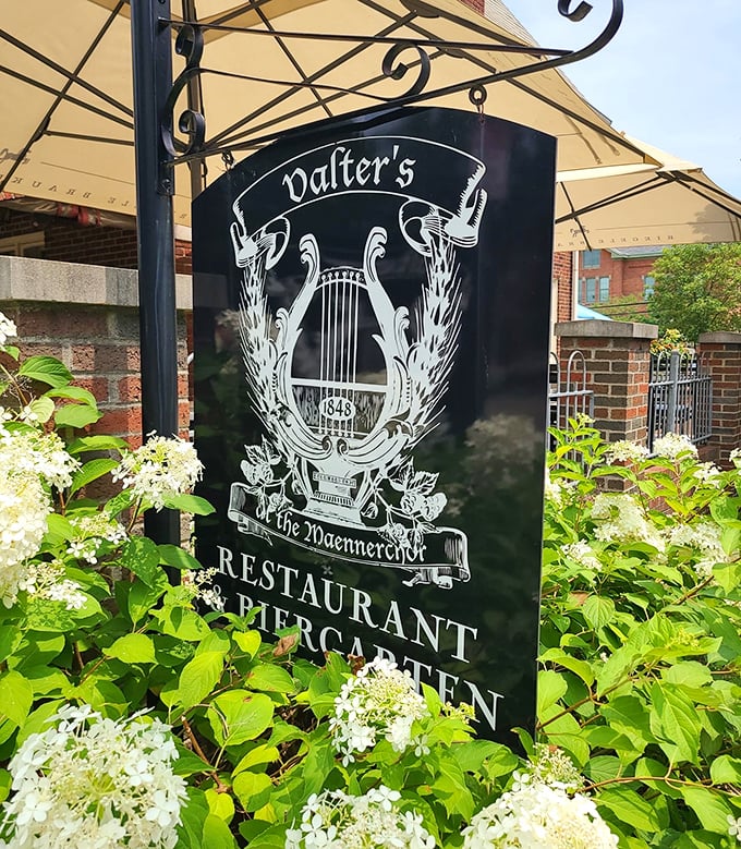 The restaurant's sign, nestled among blooming hydrangeas, hints at the harmonious blend of food and music that defines this Columbus institution.