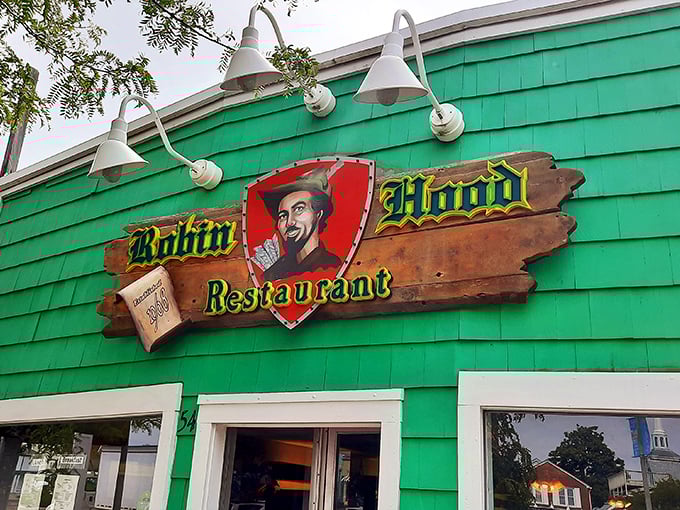 The sign says it all—this isn't some corporate chain pretending to be quaint. Robin Hood's weathered wooden sign promises authentic diner magic within.