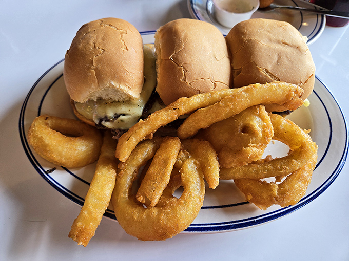These sliders and onion rings aren't just food—they're edible nostalgia that takes you back to the best roadside diners of your youth.