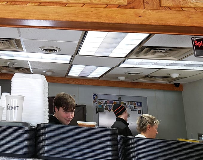 Behind the counter, where barbecue magic happens. These aren't just workers—they're keepers of the flame, guardians of the smoke.