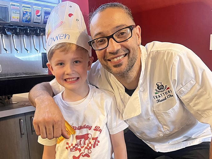 The chef's smile says it all – when you love what you do, it shows in every bite. Pizza-making isn't just a job, it's a calling.