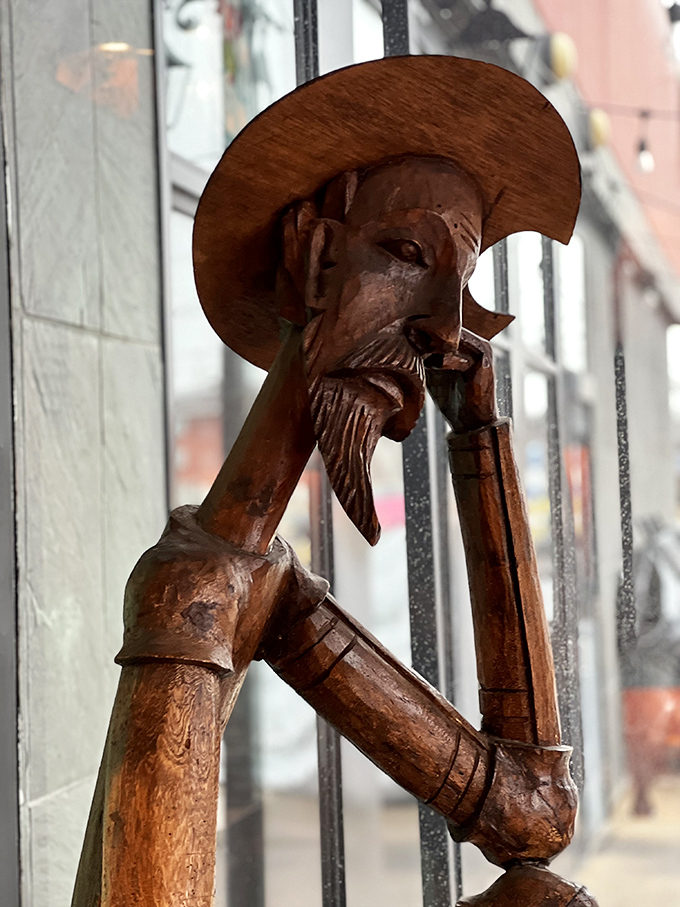 A carved wooden figure stands guard, adding authentic Mexican artistry to the restaurant's charming decor.