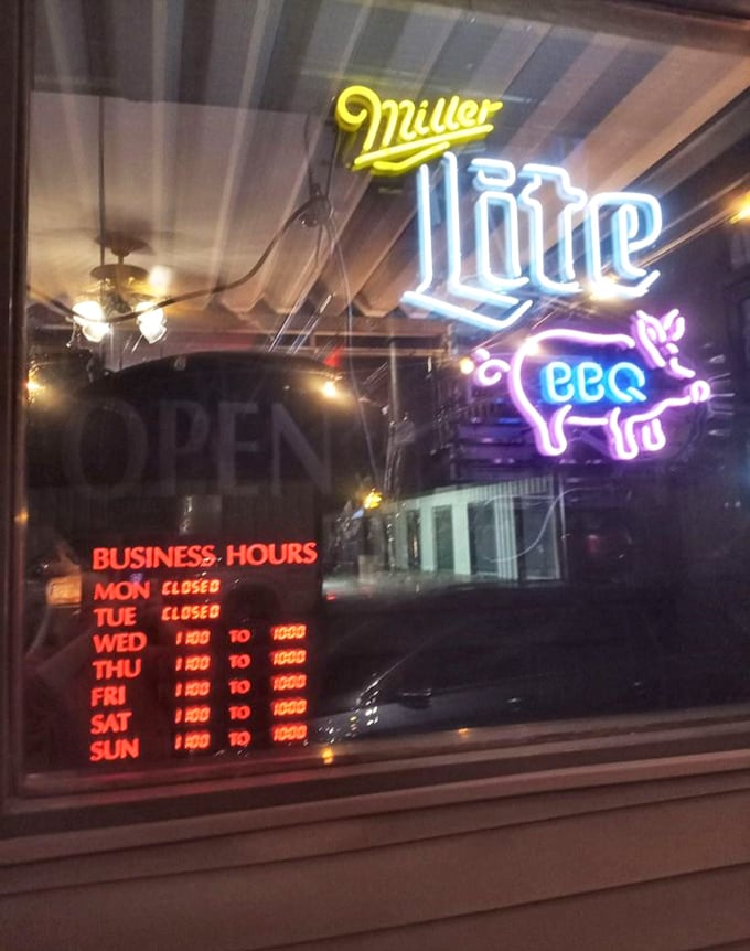 Business hours posted like a promise—when the smokers are hot, the doors are open, and happiness is served by the plateful.