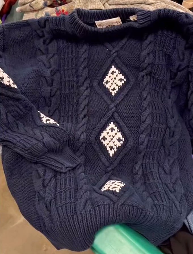 This navy cable-knit sweater with diamond accents isn't just clothing—it's a wearable hug waiting for its next adventure.