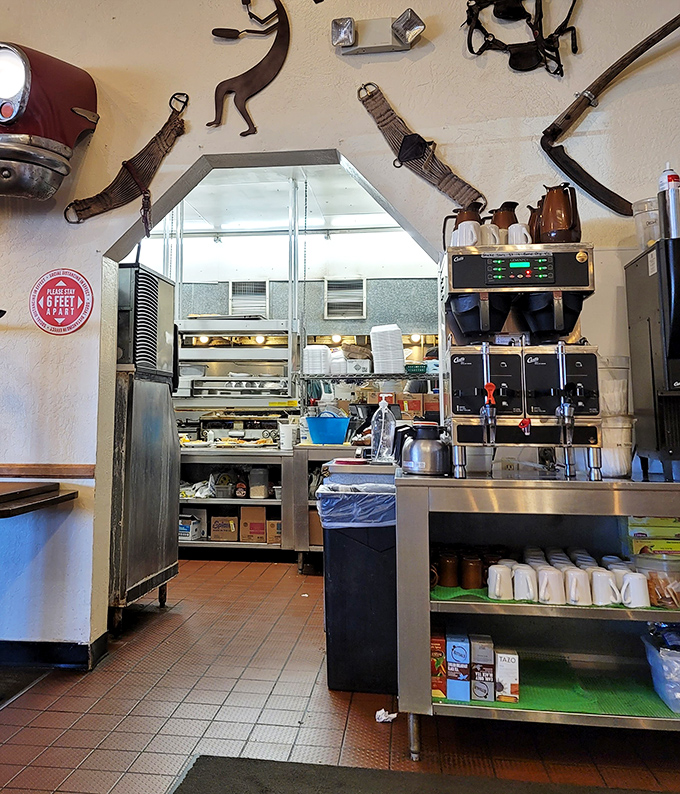 The pass to the kitchen – where breakfast magic happens behind the scenes, with decades of short-order wisdom built into every movement.