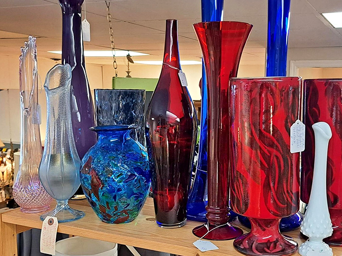 Dramatic art glass vases in jewel tones catch light and imagination. These aren't just vessels—they're sculptural statements waiting for a single perfect bloom.