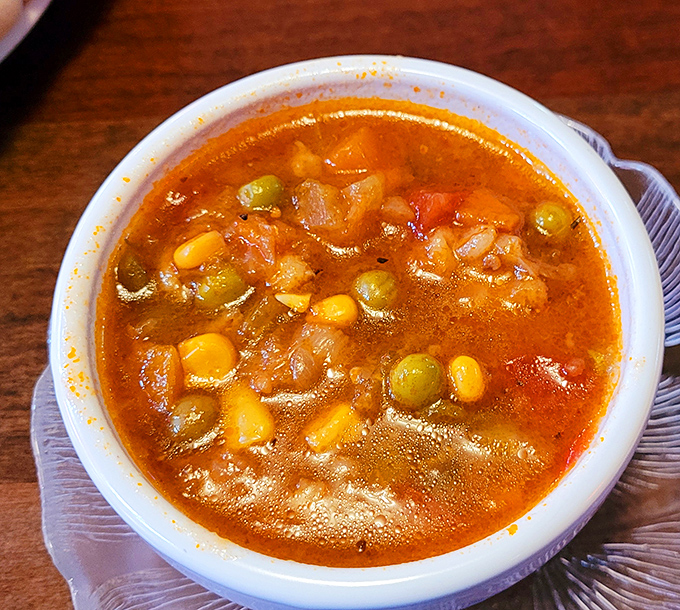 Vegetable soup that looks like it was made by someone's grandmother—hearty, honest, and packed with enough vegetables to count as a virtuous choice.