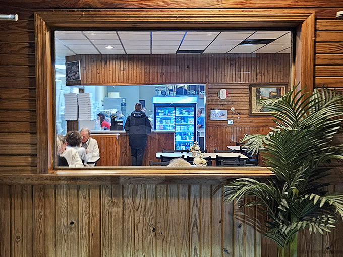 That pass-through window offers a glimpse into the promised land—where sauces simmer and dough transforms into dreams. Kitchen voyeurism at its most appetizing.