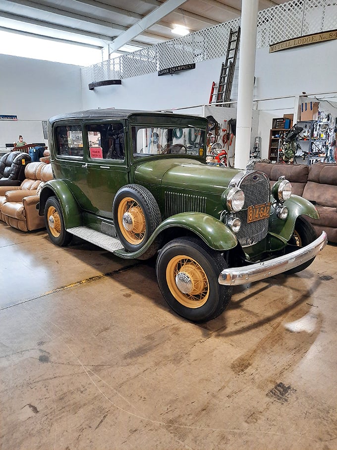 This isn't just a vintage car—it's automotive poetry in green. Those yellow-spoked wheels have stories to tell about country roads long forgotten.