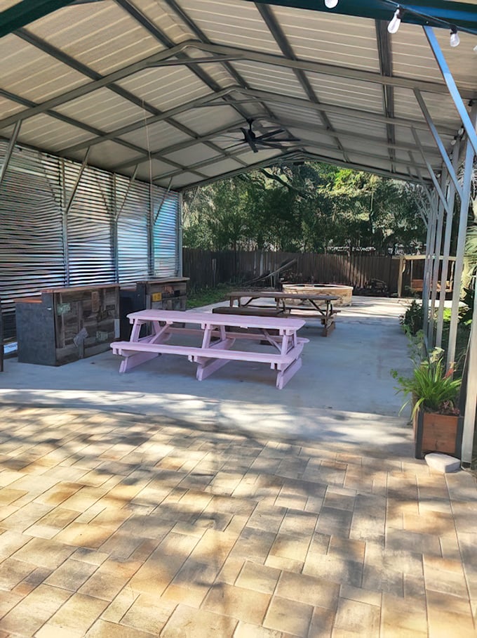 The covered outdoor seating area – where pink picnic tables invite you to enjoy your feast under Florida skies.