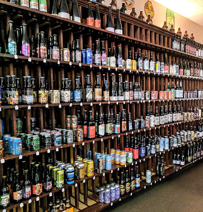 A wall of beers that would make a sommelier switch careers. This isn't a selection—it's a library of liquid happiness.