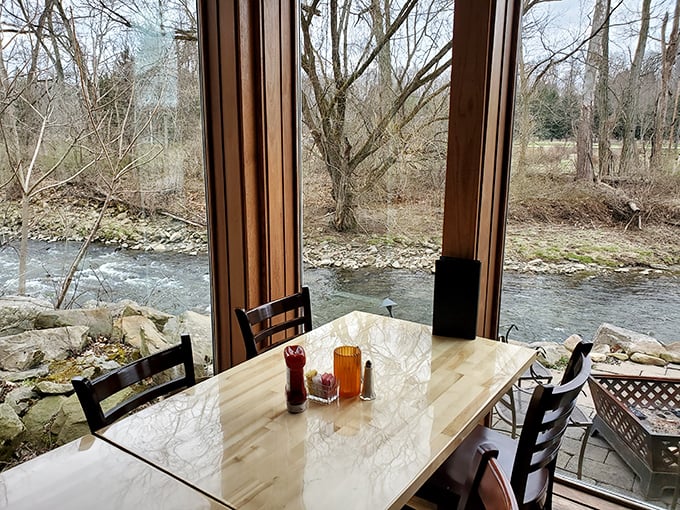 The window seat everyone fights for – dining with a front-row view of the gentle current of Tinkers Creek.
