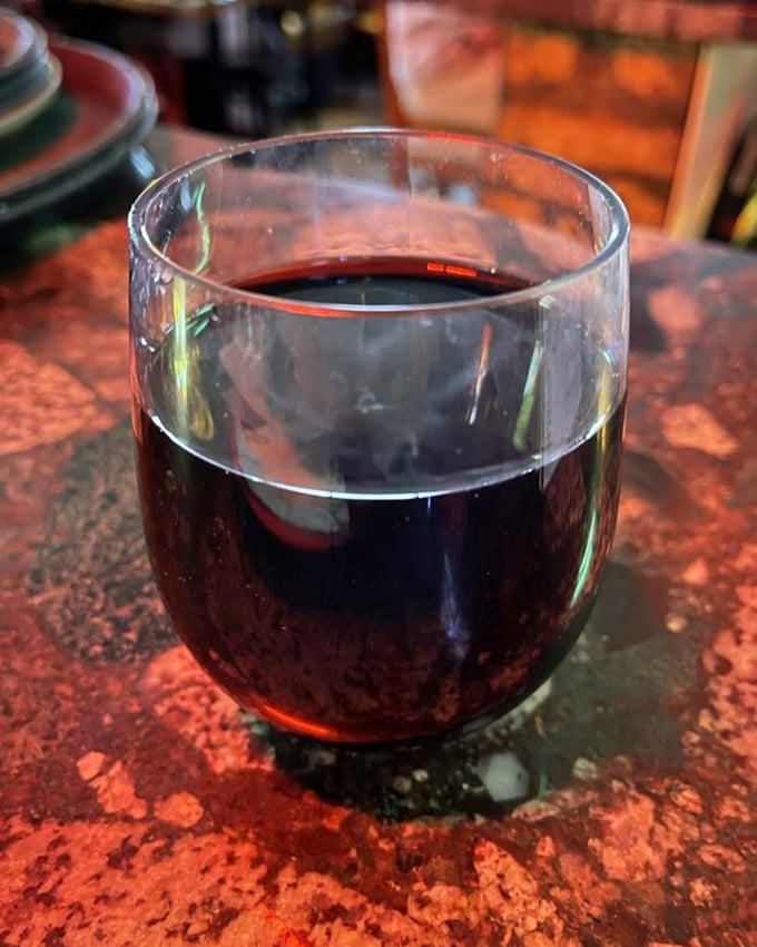 A glass of red wine – because sometimes beer just isn't enough to celebrate the religious experience that is Pequod's pizza.