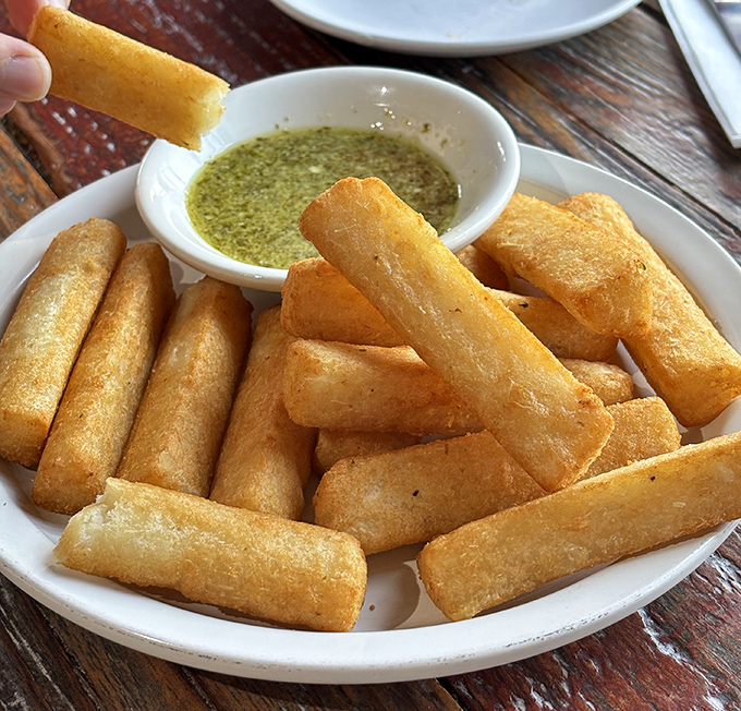 Yuca frites—crispy on the outside, pillowy within—are what French fries dream of becoming when they grow up. That dipping sauce seals the deal.