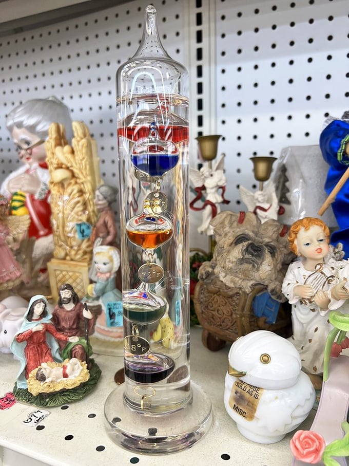 Religious figurines surround a Galileo thermometer in perfect thrift store harmony. Science and faith together at last—for just a few dollars!