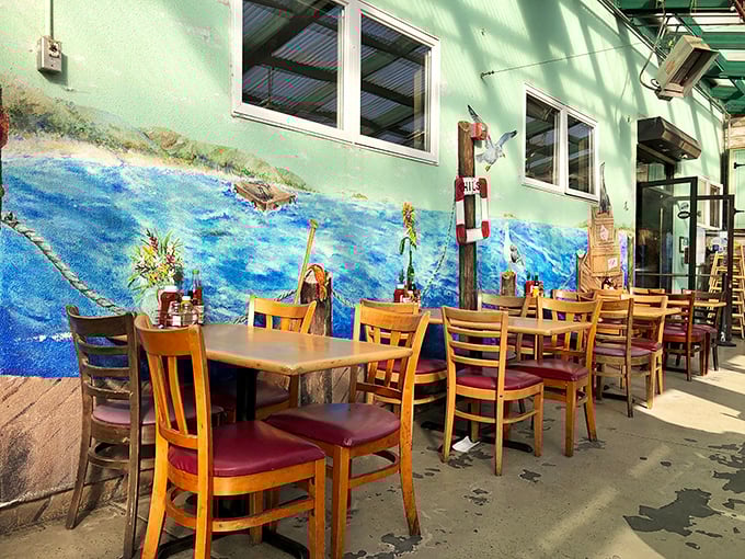 Al fresco dining with a side of ocean-inspired murals – because sometimes your seafood needs the proper artistic backdrop.