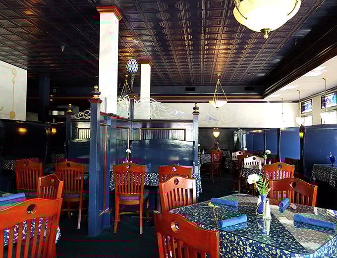 Red chairs pop against navy walls in this dining room where comfort meets class. The kind of place where memories are made between courses.